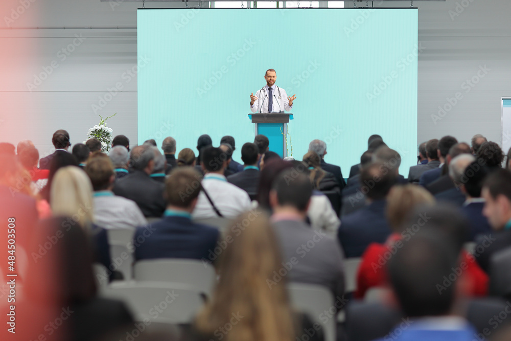 Male doctor giving a speech on a podium at a conference Stock Photo ...
