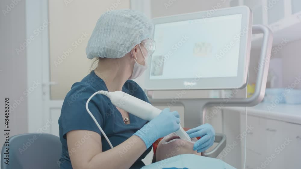 Orthodontist using 3D intraoral scanner for scanning teeth patient's ...