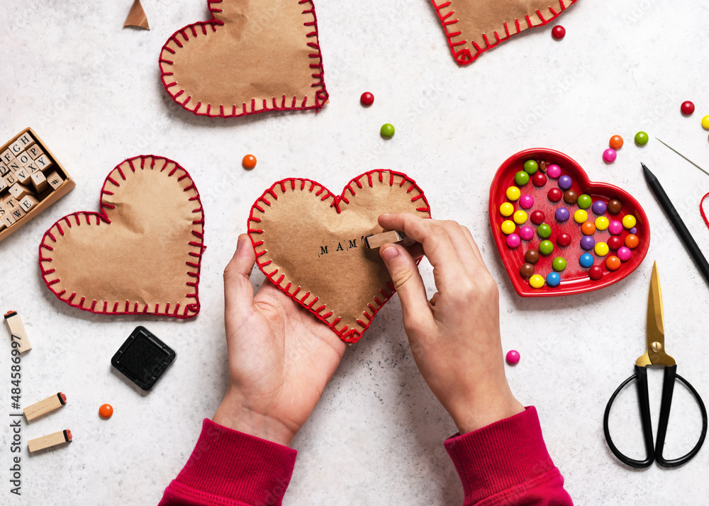 Step 5. "MAMA" word stamped by kids hand on the paper heart with with ...