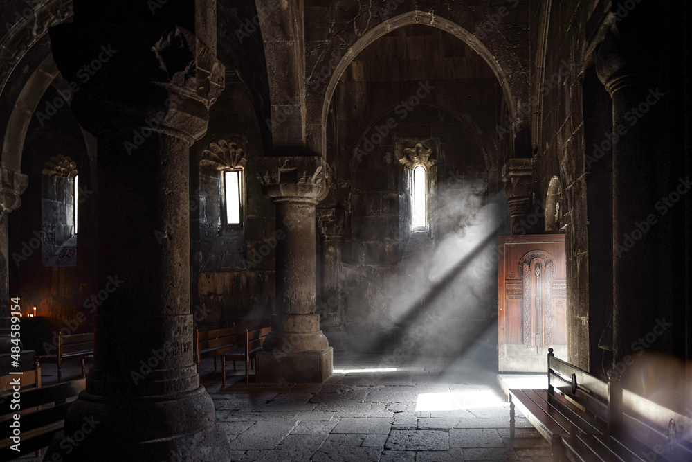 Stone interior with arch and column of Ancient Armenian church in the ...