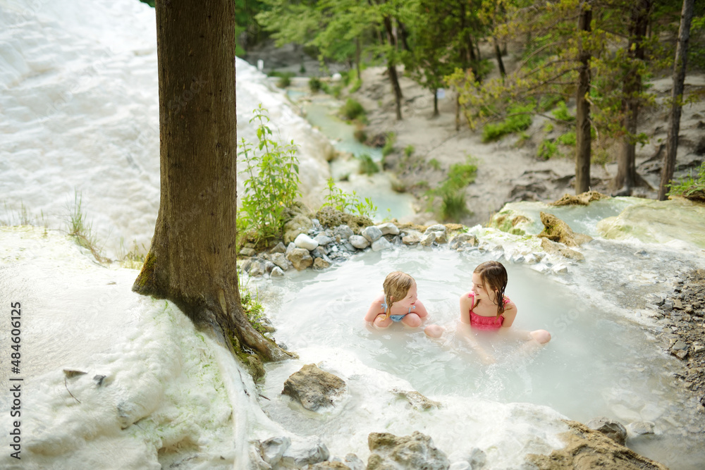 Young girls bathing in Bagni San Filippo, small hot spring containing ...