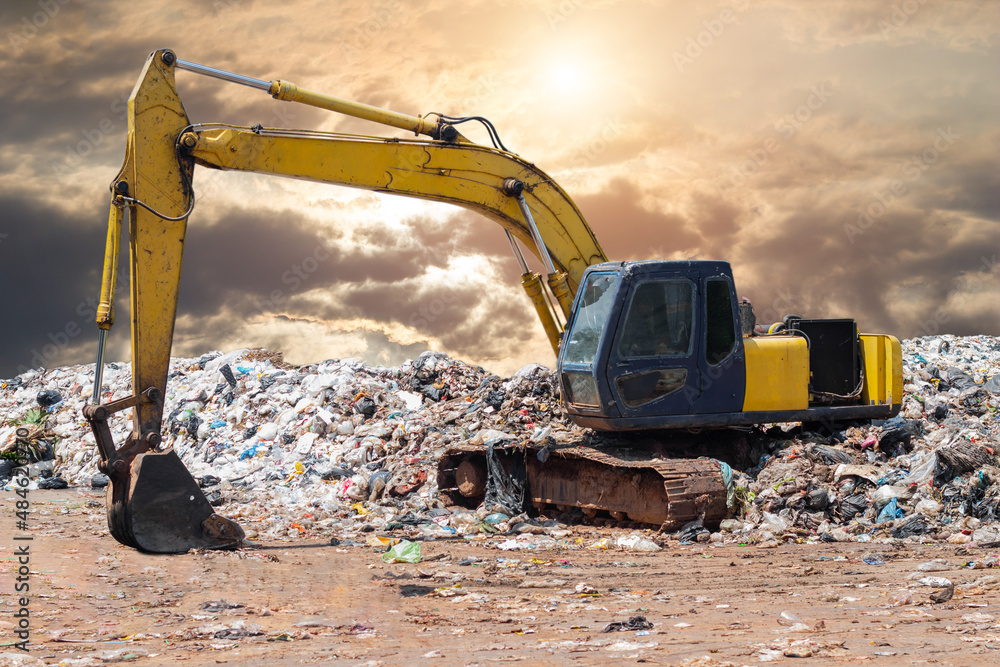 backhoe in the gabage from municipal, garbage dump pile and sky ...