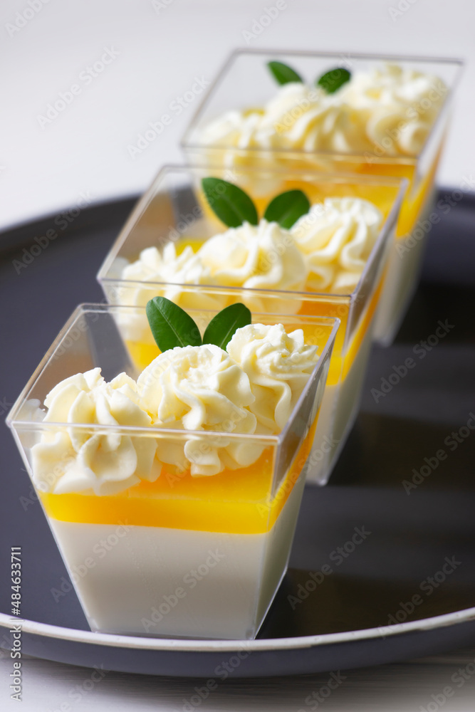 Orange panna cotta in a portion cups, citrus fruits dessert, low ...