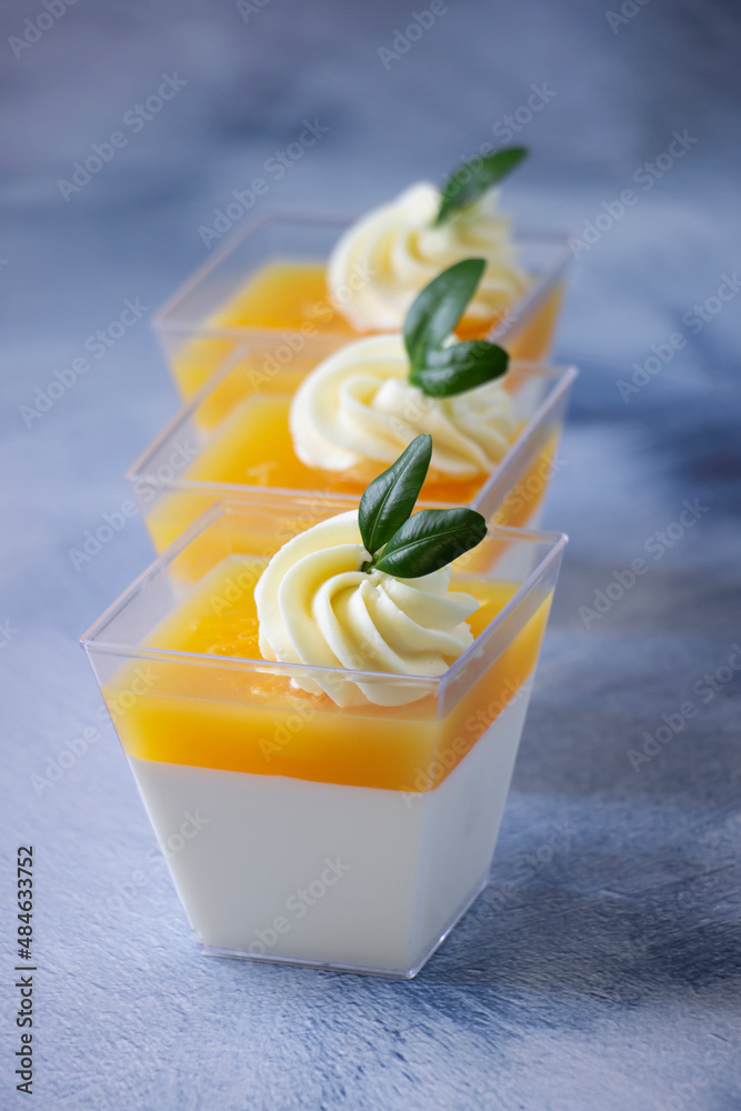 Orange panna cotta in a portion cups, citrus fruits dessert, low ...