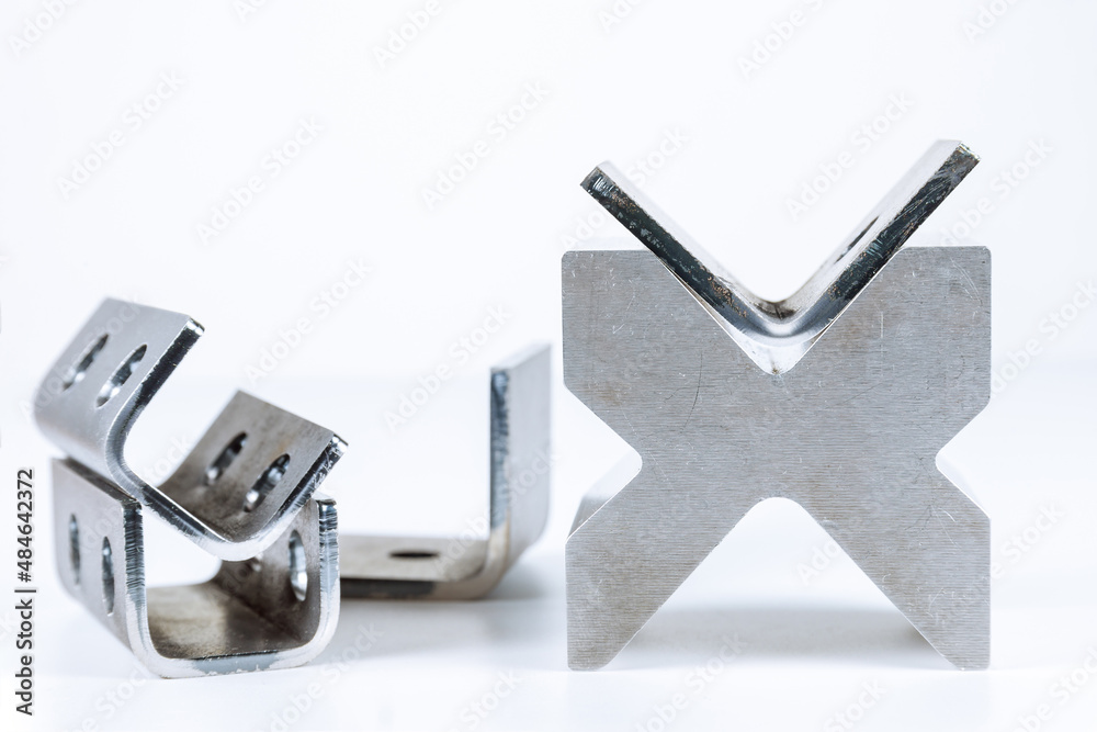 Equipment for bending sheet metal on a CNC bending machine on a white ...