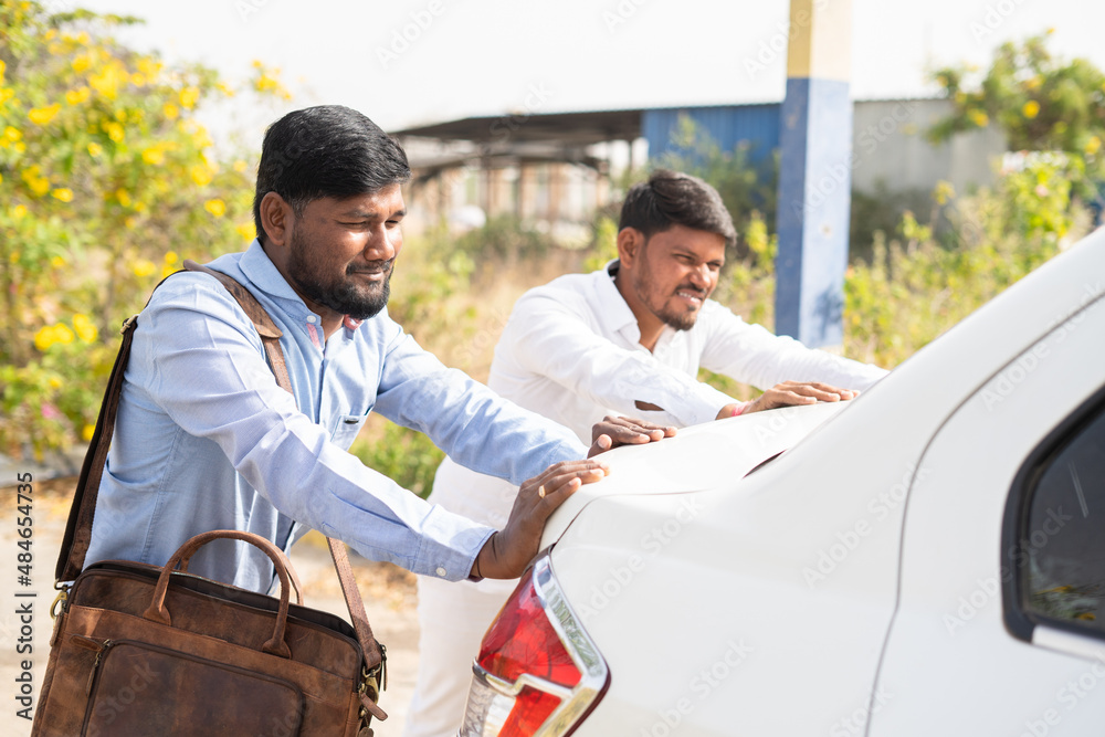 Side view shot of Worried cab driver and passanger pushing the car on ...