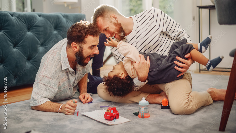 Loving LGBTQ Family Playing with Toys with Adorable Baby Boy at Home on ...