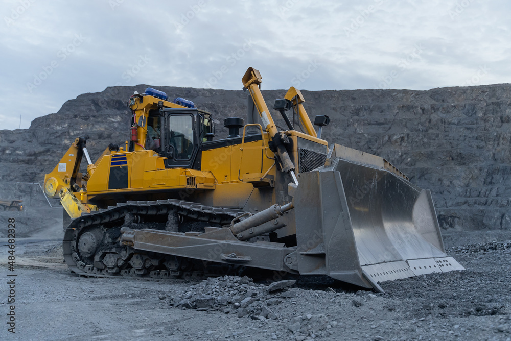 Bulldozer at night. The action takes place at a gold mining site in an ...
