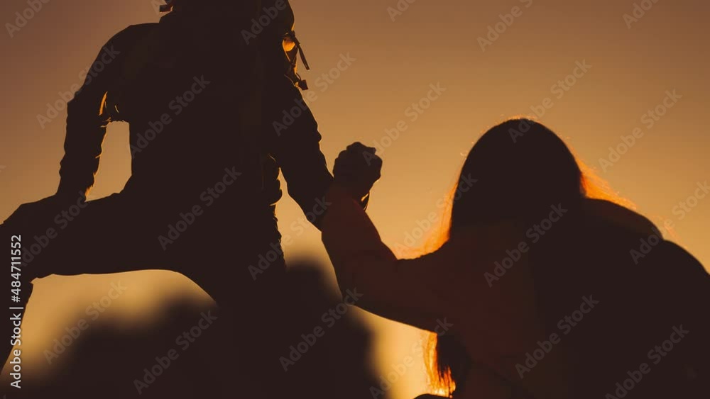 help team concept. couple team silhouette of two climber stretching a ...