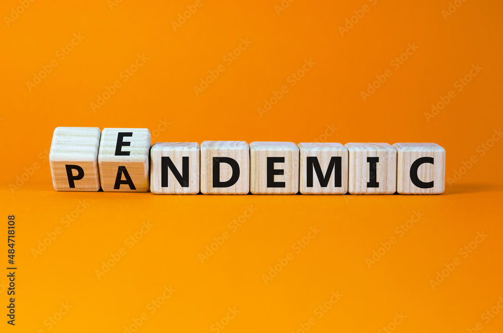 Covid-19 pandemic or endemic symbol. Turned wooden cubes and changed ...