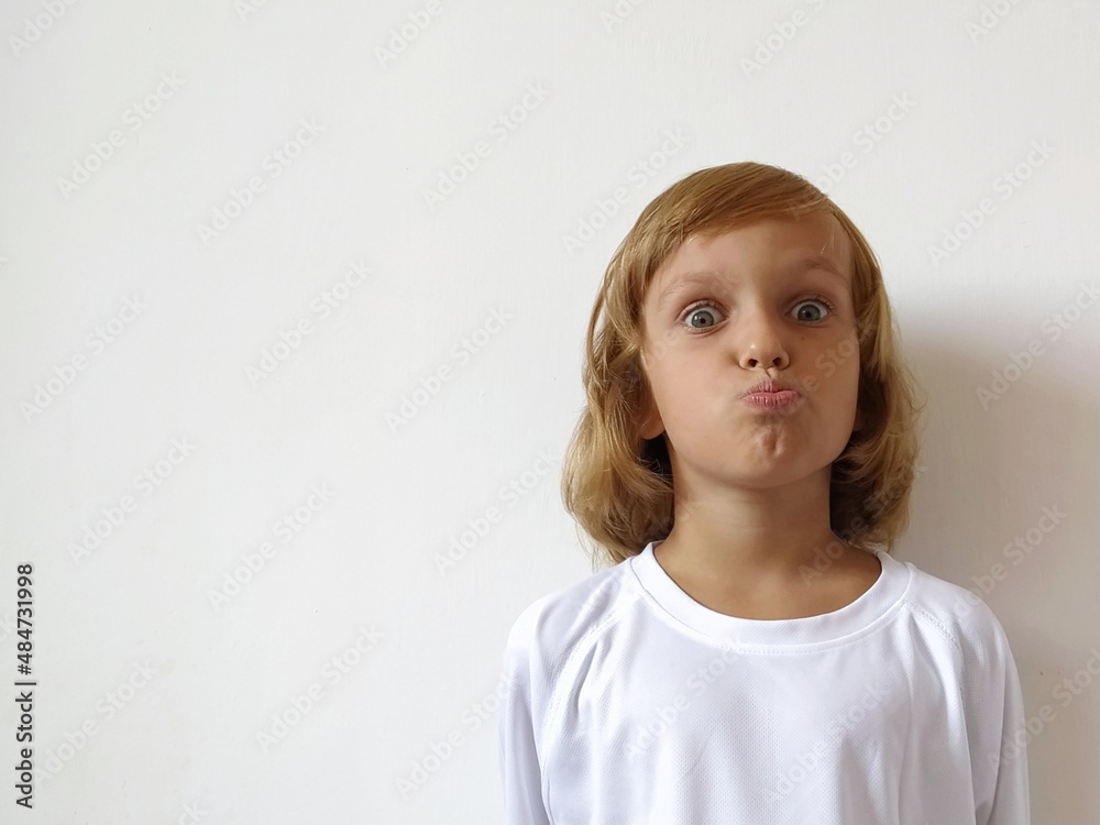 Little cute girl with blond hair on a white background. Tanned skin ...