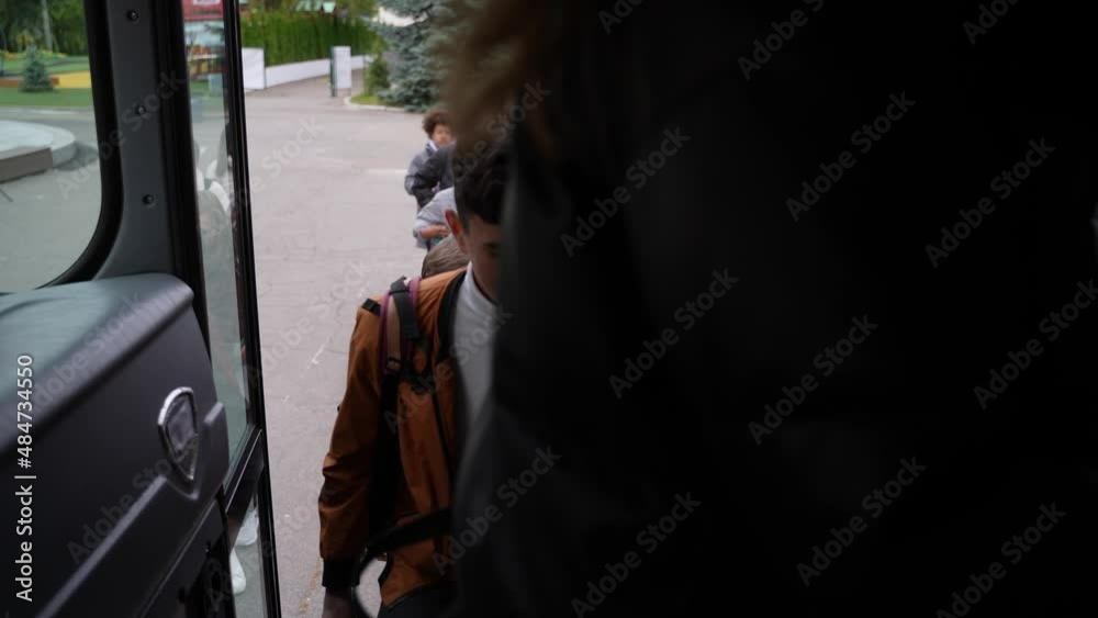 Closeup of multinational secondary school pupils taking turns entering ...