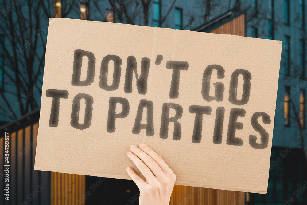 The phrase " Don’t go to parties " on a banner in men's hand with ...