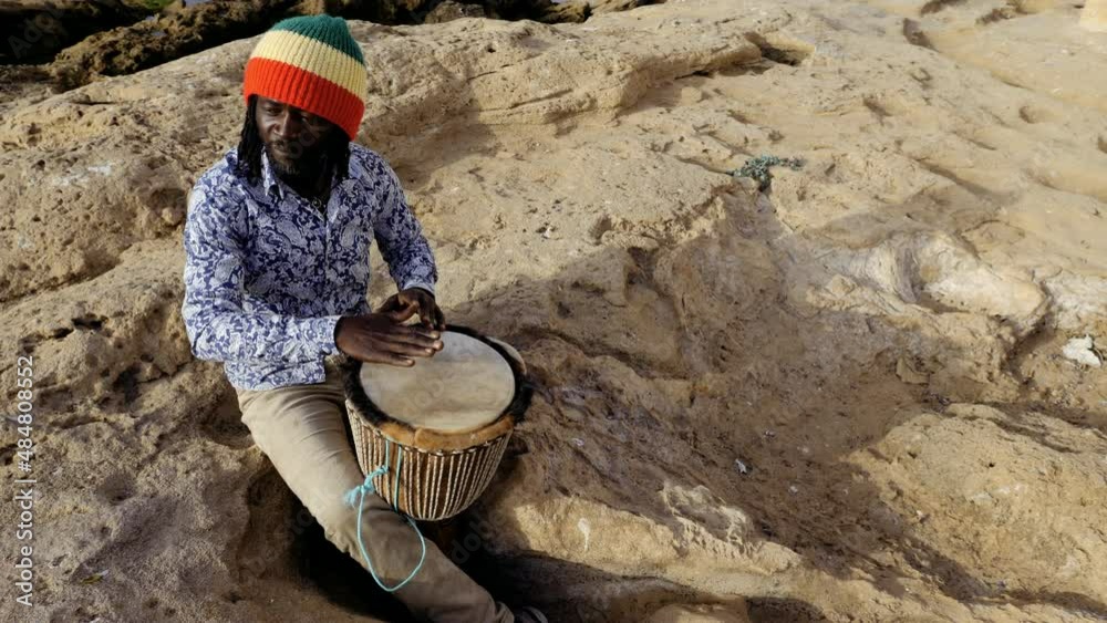 African percussion music, a Senegalese man plays a traditional djembe ...