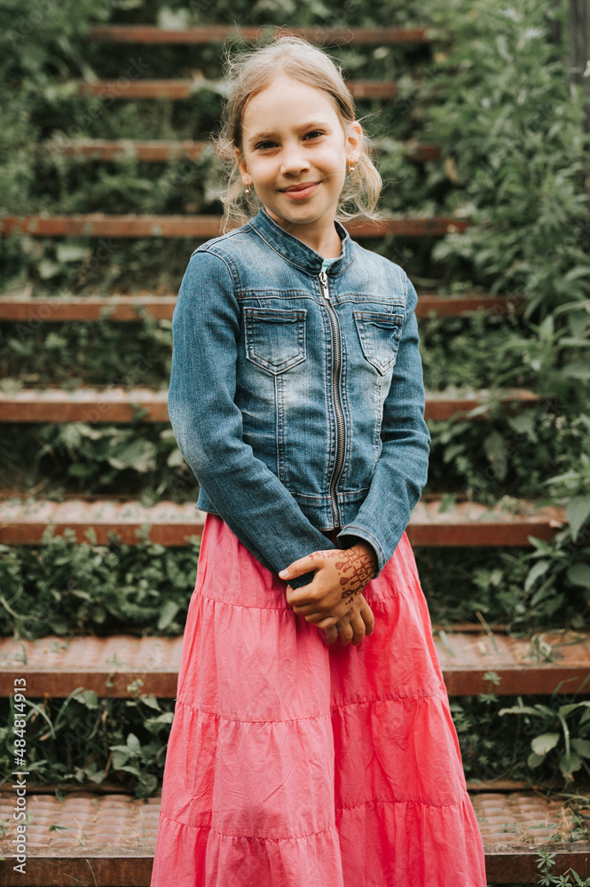 happy smiling candid eight year old kid girl stands on staircase ...