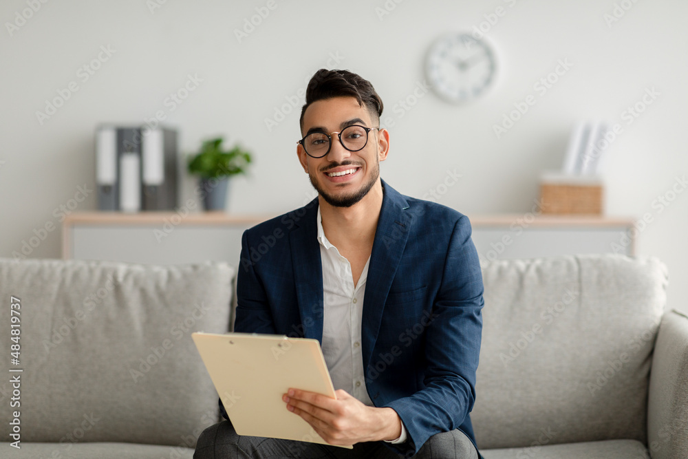 Foto de Portrait of happy arab male psychologist smiling at camera and ...