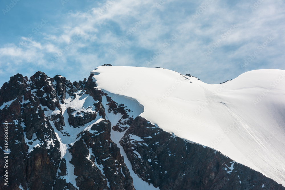 Minimalist alpine landscape with snow-covered mountain top and sharp ...