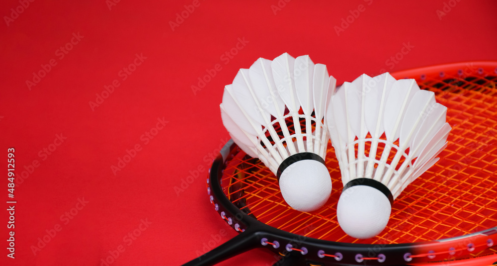 Cream white badminton shuttlecock and racket on floor in indoor ... Cream white badminton shuttlecock and racket on floor in indoor ...