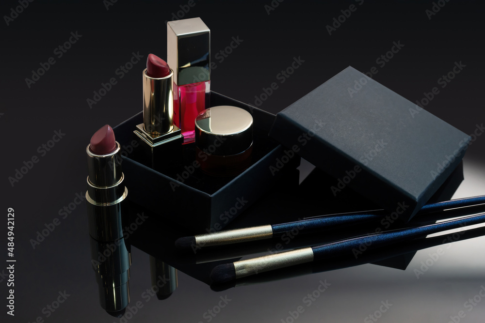 set of cosmetics for a female face and eye makeup in a black craft box ...