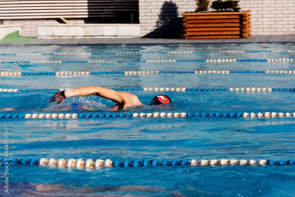 Professional male swimmer swimming in the pool Stock Photo | Adobe Stock