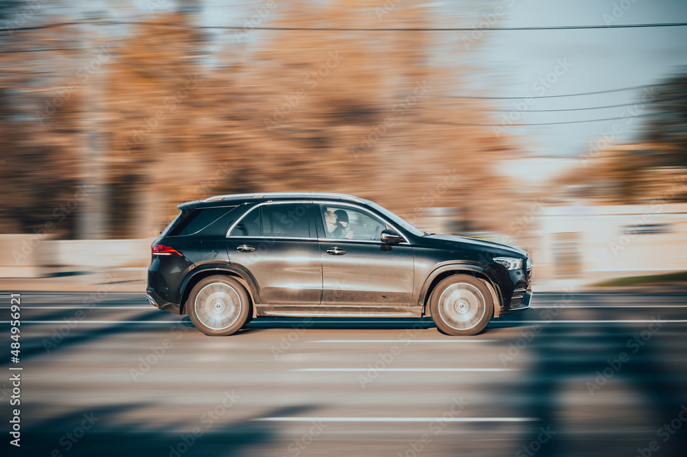 Mercedes GLE 350D car is driving fast against urban background ...