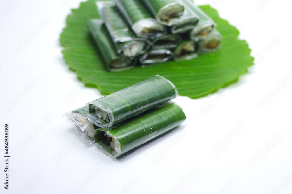 Indonesian traditional snack called Lemper on banana plate isolated on ...