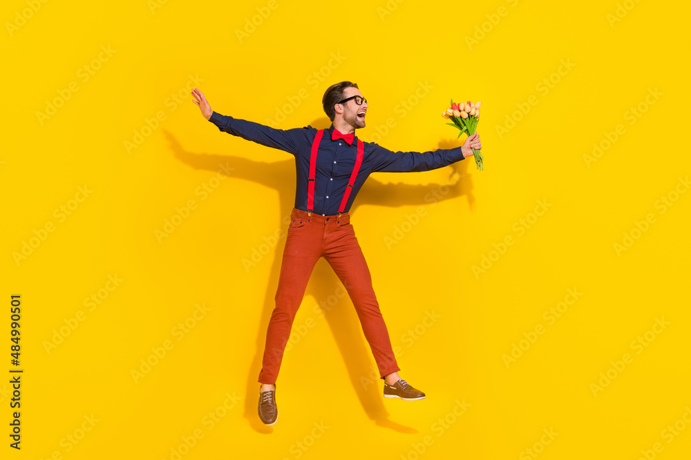 Full size photo of young man jump up give bunch of tulips holiday ...