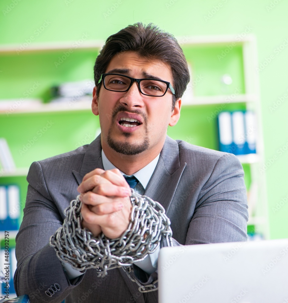 Employee chained to his desk due to workload Stock Photo | Adobe Stock