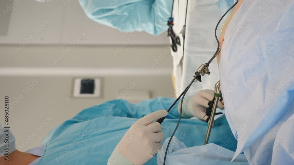 Laparoscopic instruments in action during abdomen surgery. Closeup shot ...
