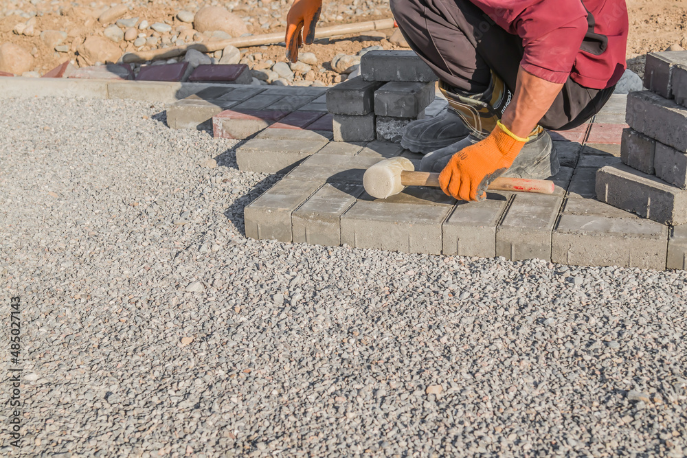 Laying paving slabs by hand on a construction site Stock Photo | Adobe ...