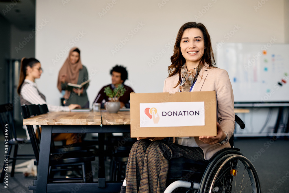 Happy wheelchair-bound charitable foundation founder holding donation ...