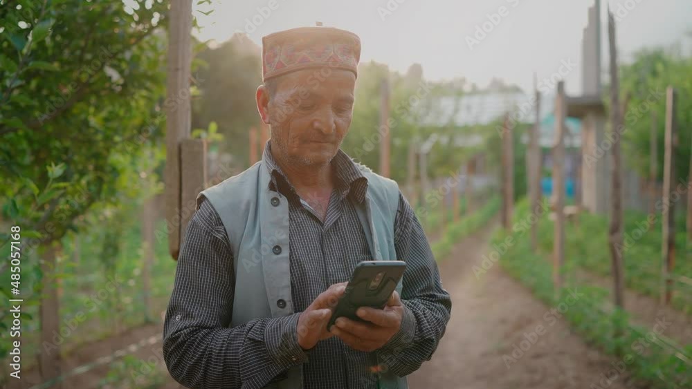 A middle aged Indian Asian rural man or male farmer in traditional ...
