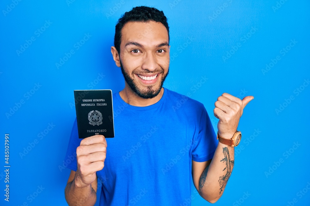 Foto de Hispanic man with beard holding italy passport pointing to the ...