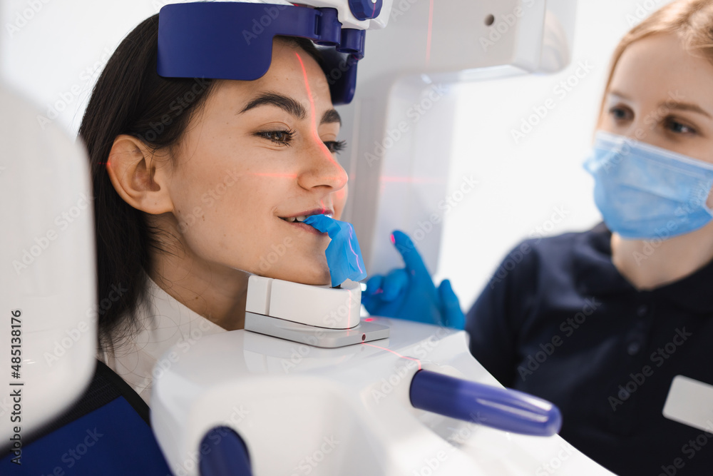 Female patient make a dental computer tomograph. The radiologist makes ...