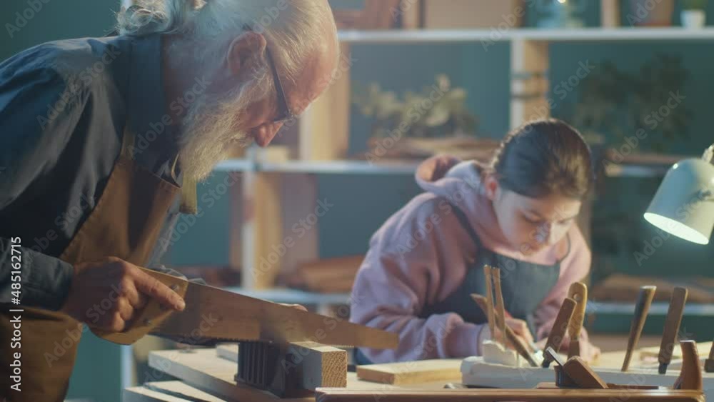 Grandfather Carpenter with his Teenage Granddaughter Work on Wood With ...