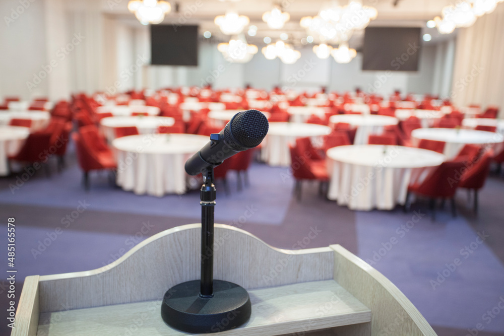 Interior of a conference room. Detail of a microphone sitting on a desk ...