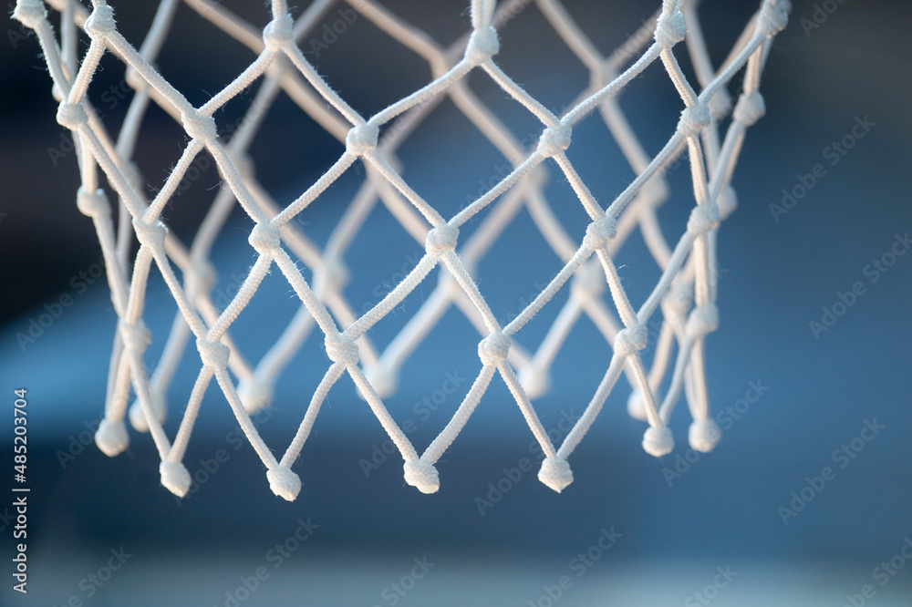 Empty swooshing basketball net closeup with blue background. Horizontal ...