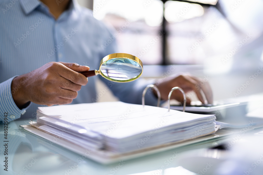 Auditor Using Magnifying Glass For Audit Stock Photo | Adobe Stock