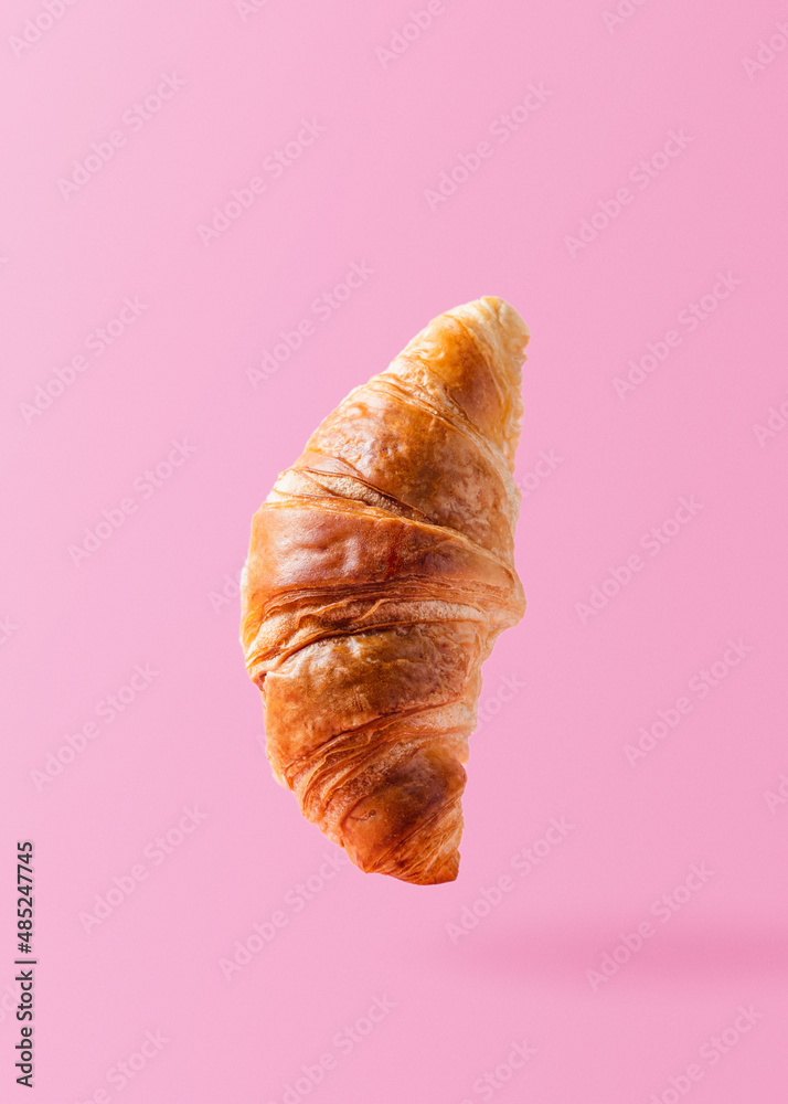 Freshly baked croissant levitating or flying. Croissant fly in the air ...