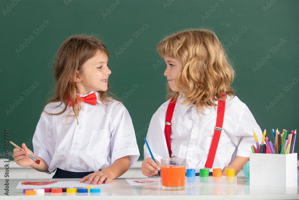 Funny pupils draws in classroom on school blackboard background. School ...
