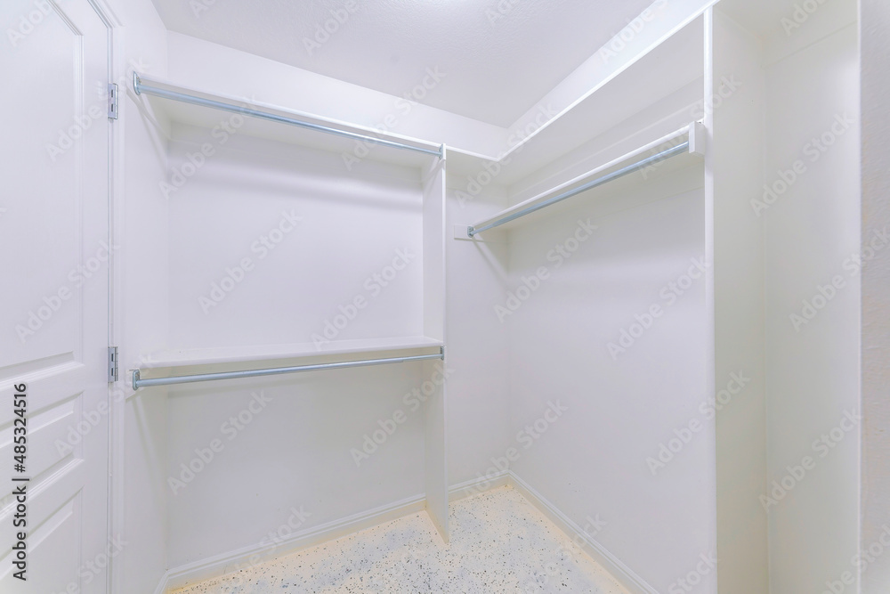 Small walk-in closet interior with white door and walls Stock Photo ...
