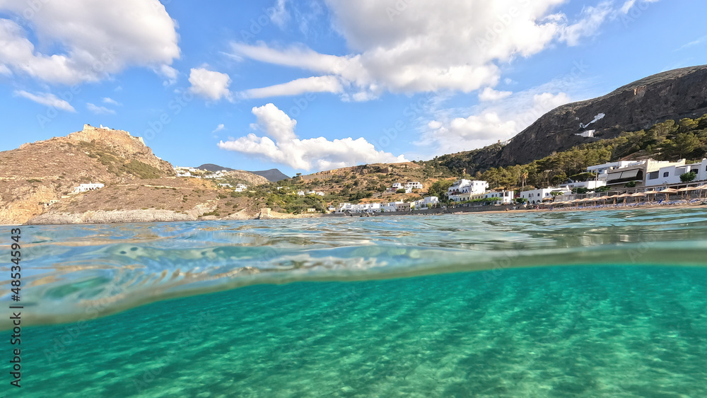 Underwater split photo taken from beautiful emerald bay and beach of ...