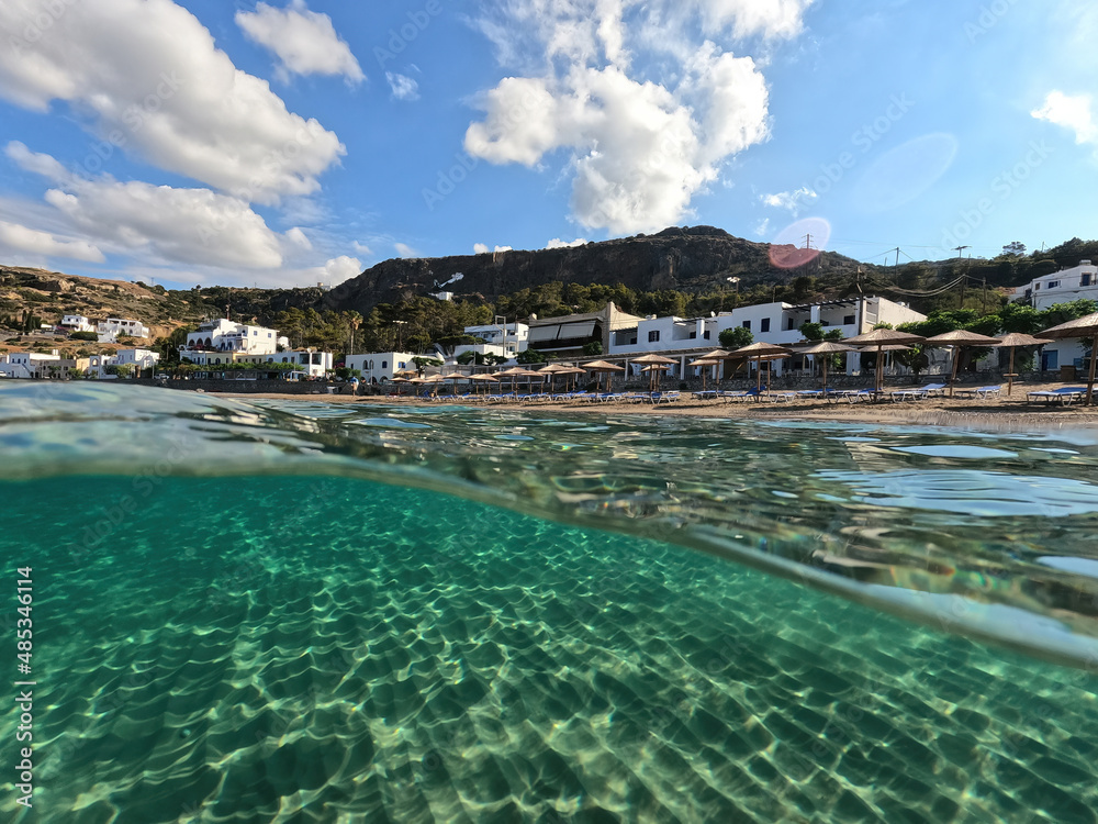 Underwater split photo taken from beautiful emerald bay and beach of ...