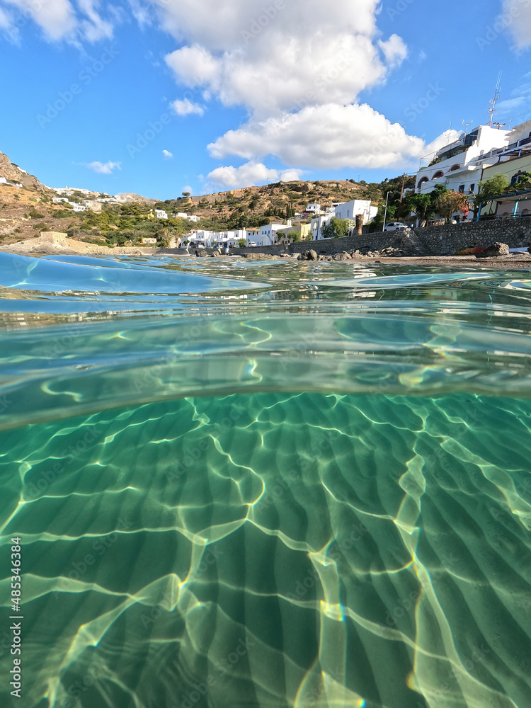 Underwater split photo taken from beautiful emerald bay and beach of ...