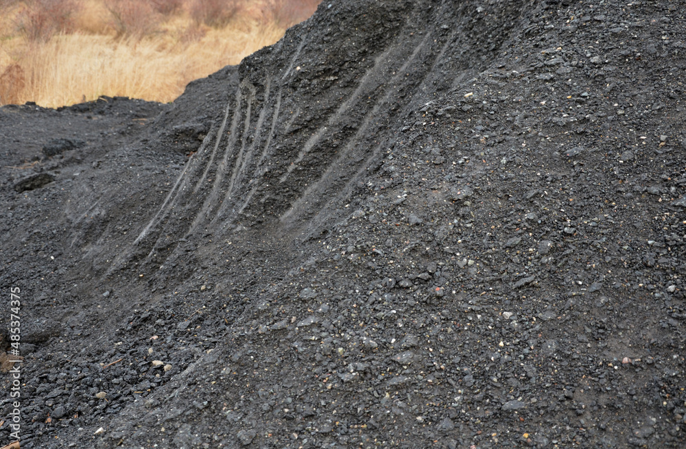 recycled asphalt from road milling on a large pile at a landfill ...