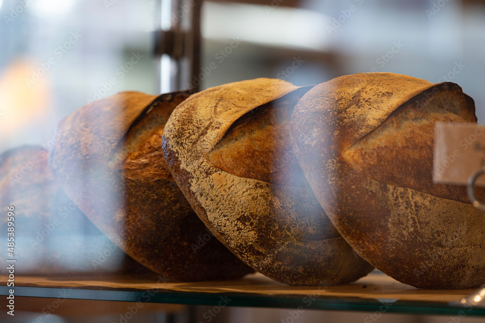 loaves of bread through bakery window Stock Photo | Adobe Stock