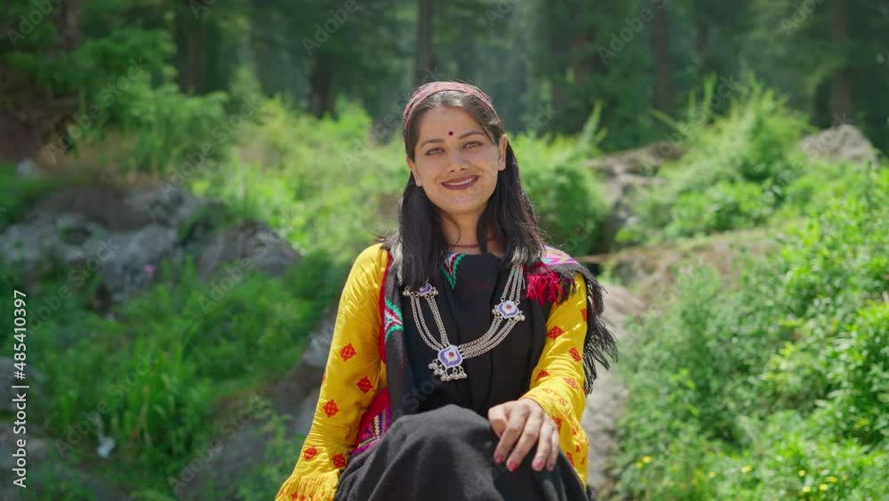 Track in shot of a young happy Indian Asian beautiful Rural Woman ...
