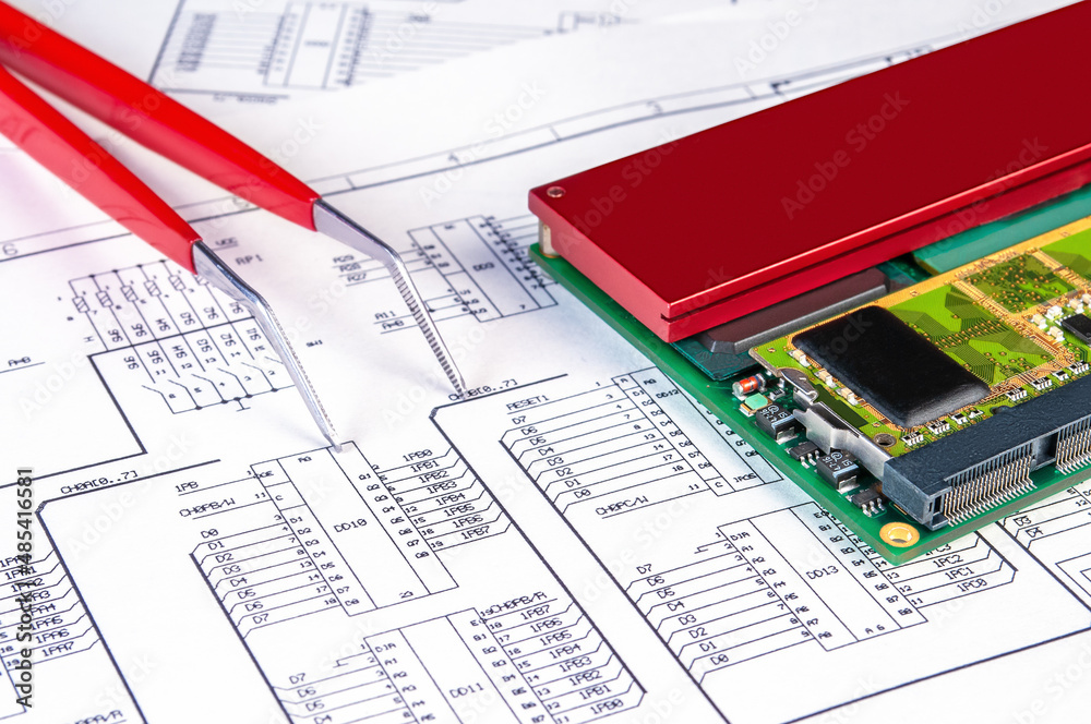 Electronic board and tweezers on background of schematic circuit ...