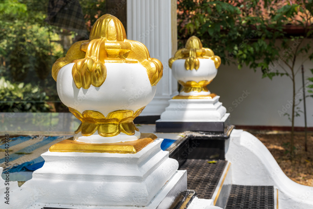 Filled pot (Punkalasa) painted in white and gold in a Sri Lankan temple ...