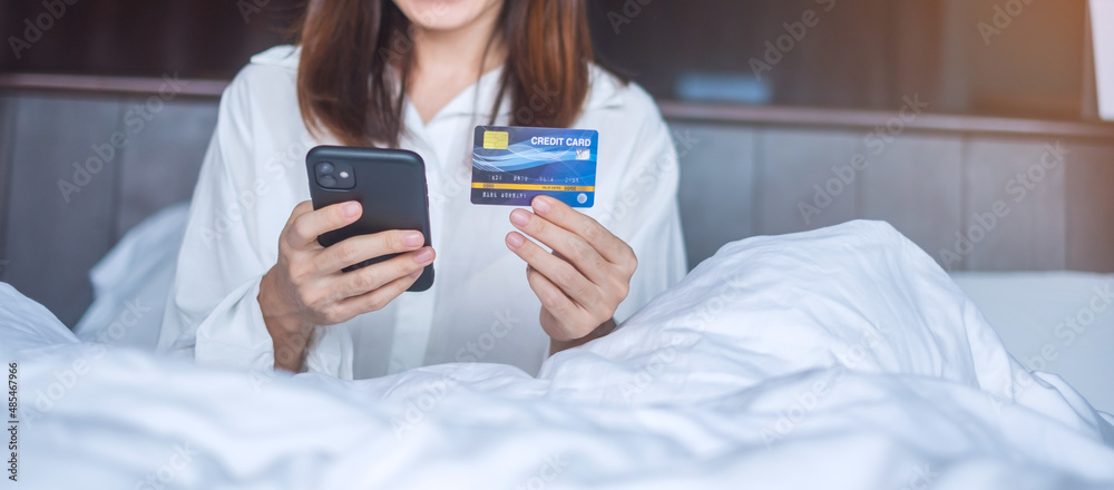 woman using mobile smart phone and credit card for online shopping ...
